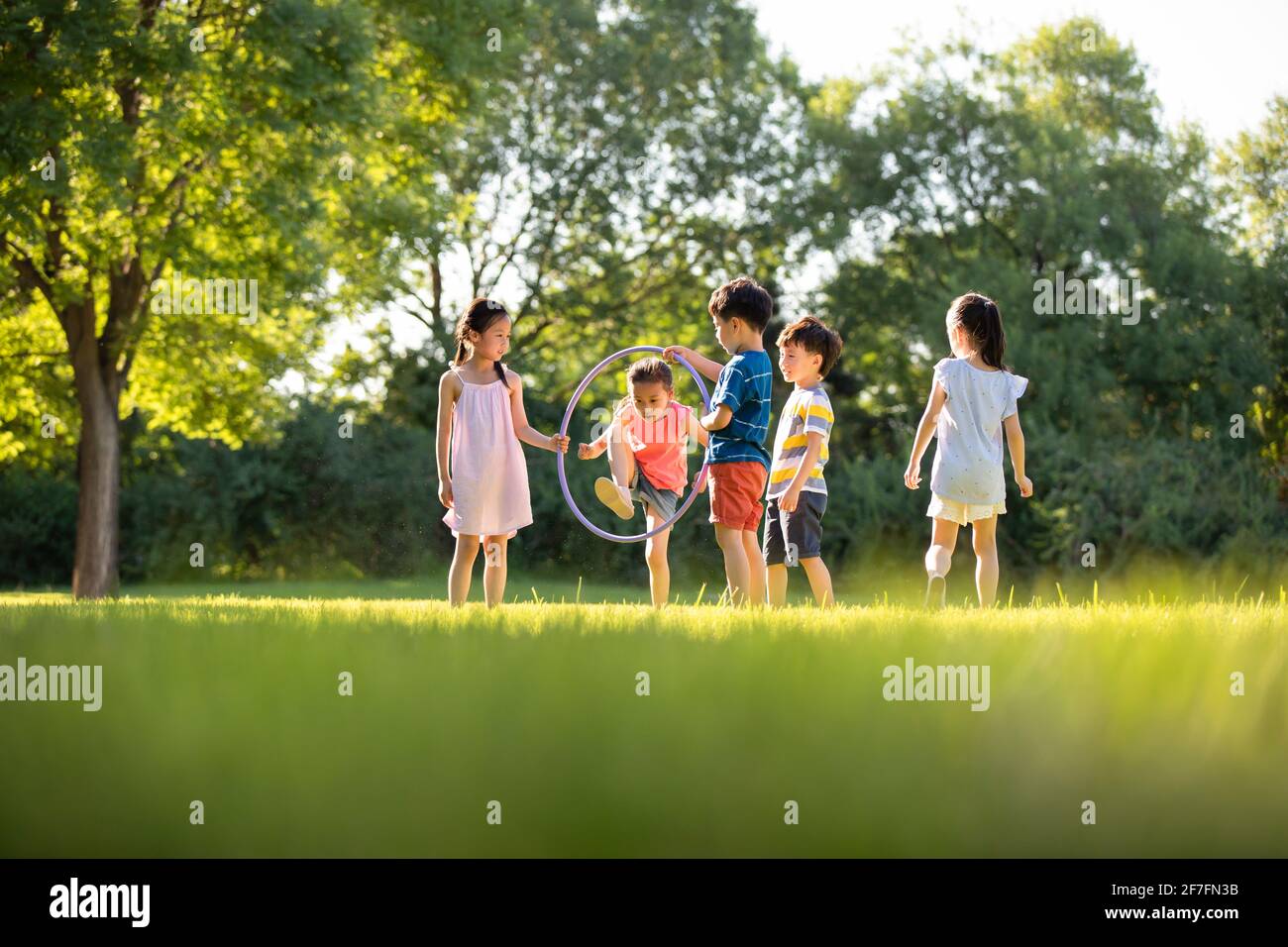 Happy children playing on meadow Stock Photo - Alamy