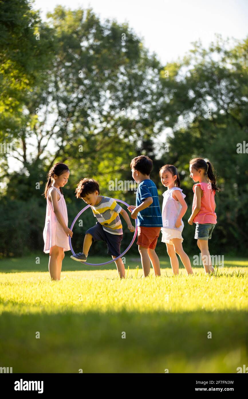 Happy children playing on meadow Stock Photo - Alamy