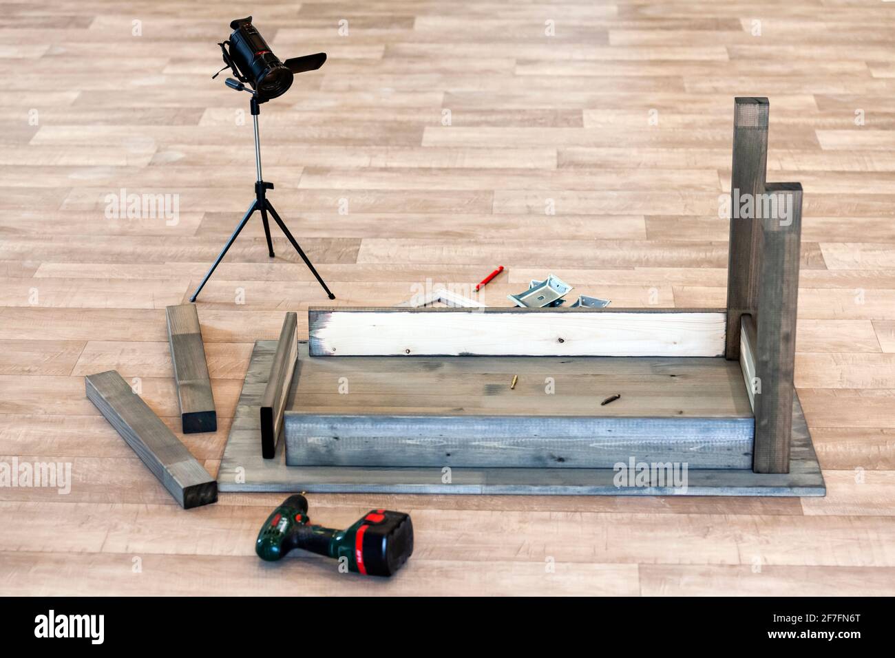 Online assembling of a wooden table. Video camera shooting a process of ...