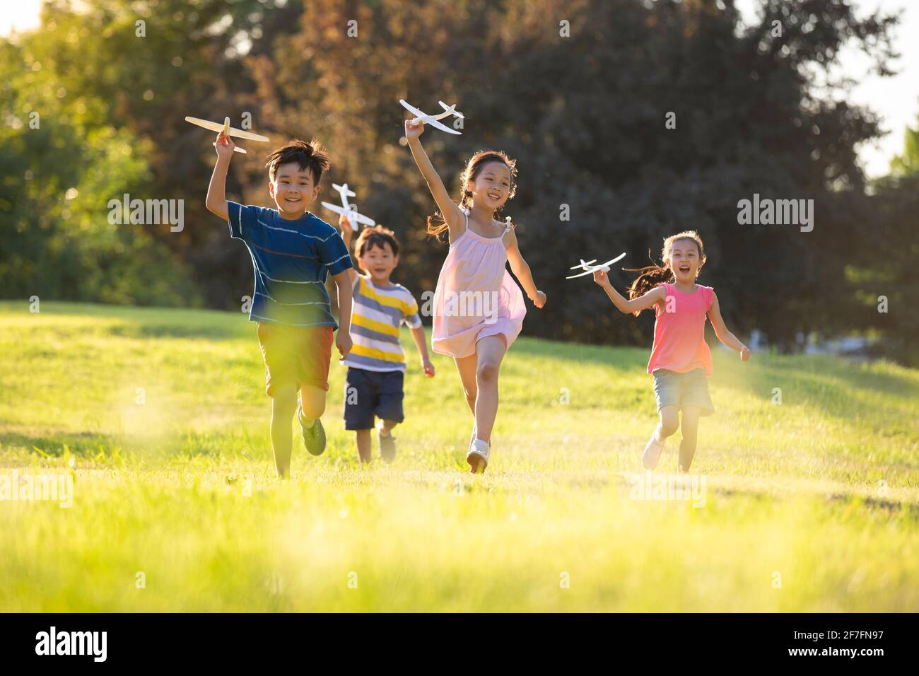 Happy children playing on meadow Stock Photo - Alamy