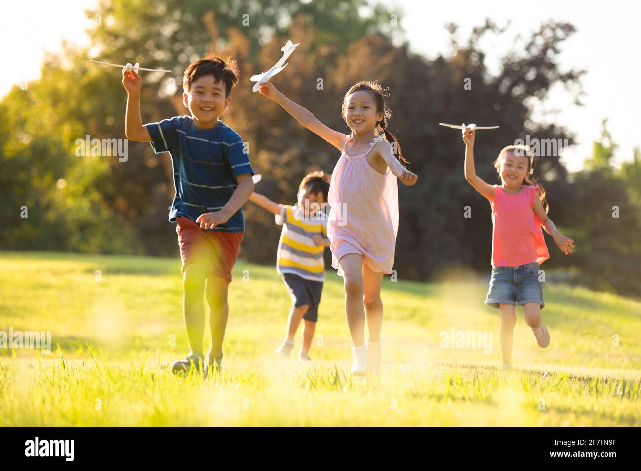 Happy children playing on meadow Stock Photo - Alamy