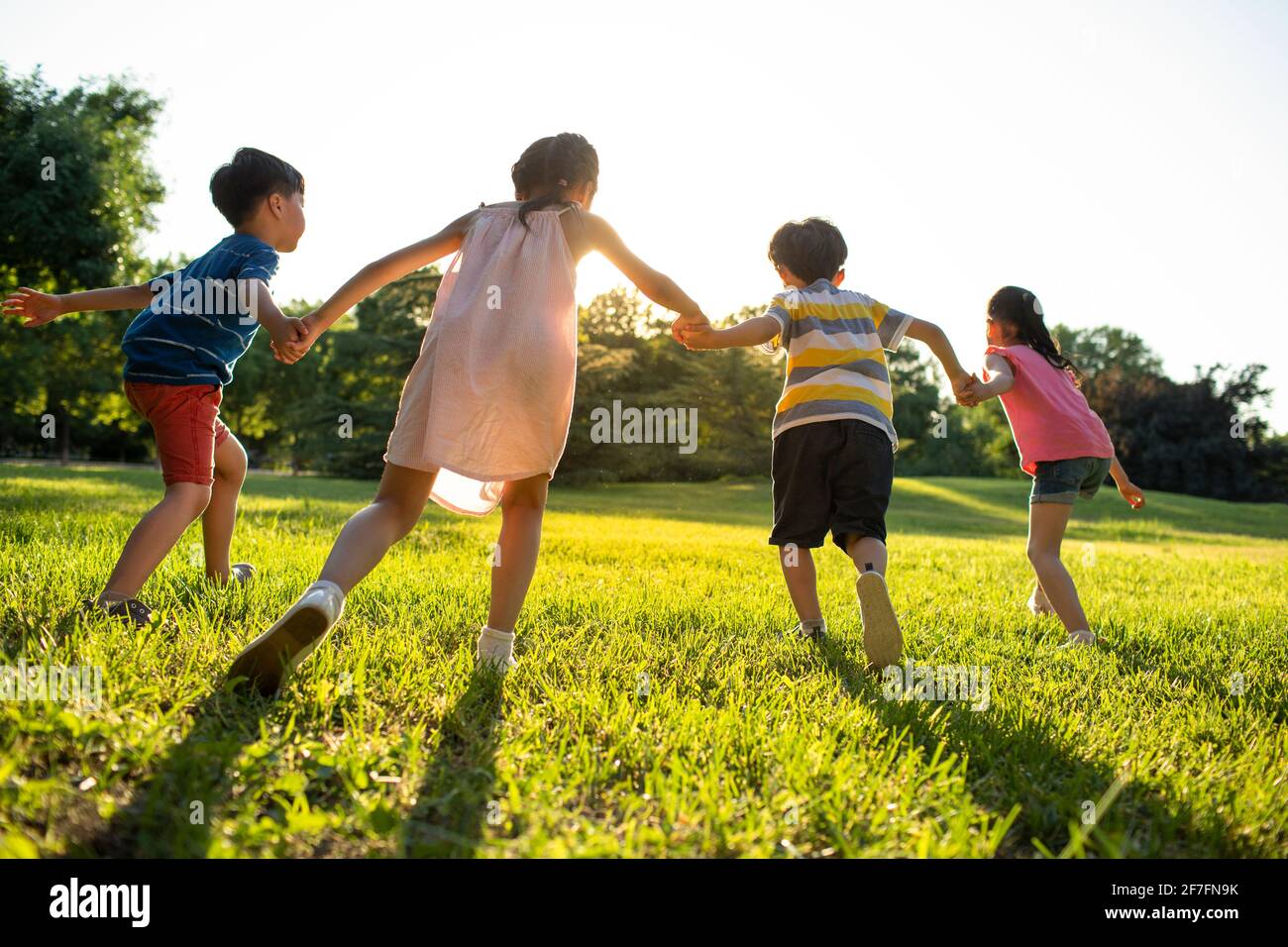 Children running on meadow Stock Photo - Alamy