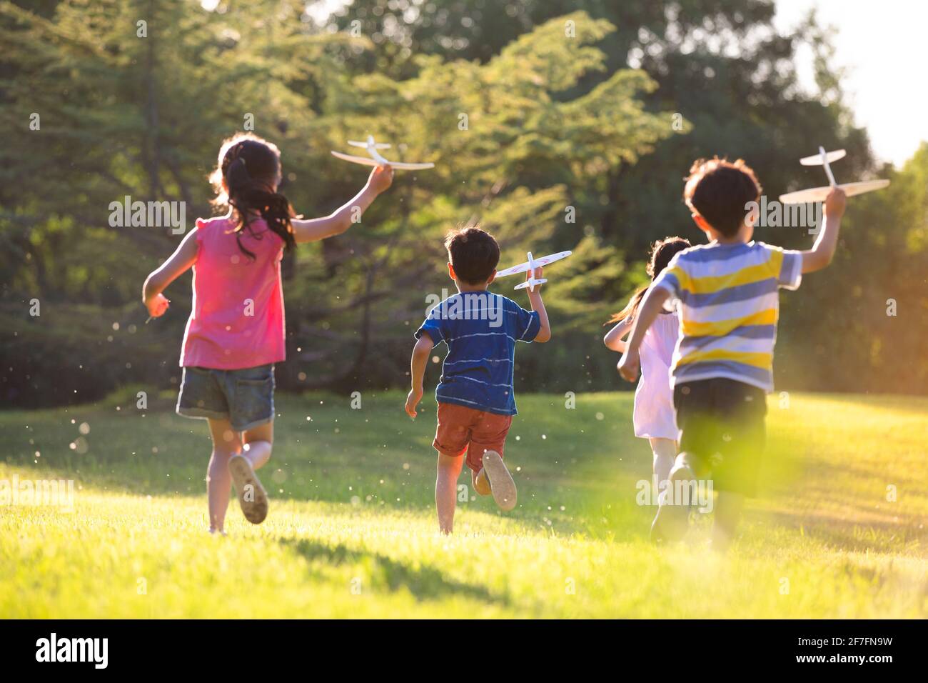 Little children playing on meadow Stock Photo - Alamy
