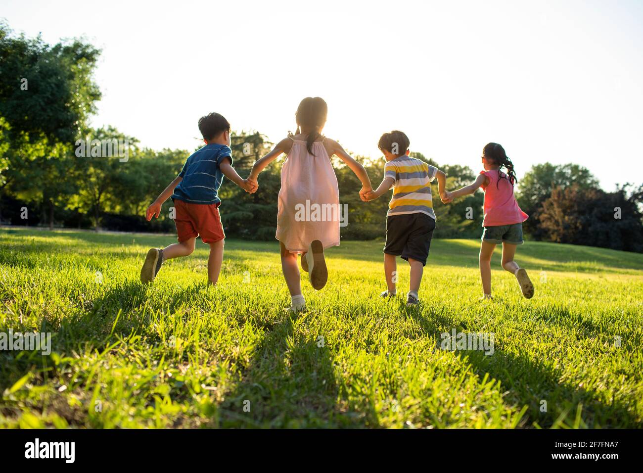 Children running on meadow Stock Photo - Alamy