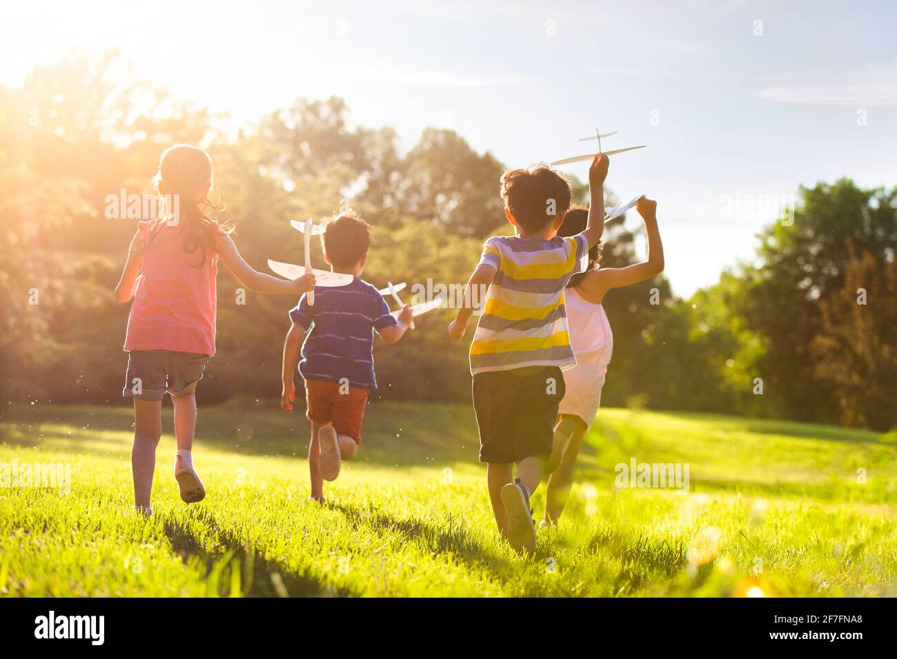 Happy children playing on meadow Stock Photo - Alamy