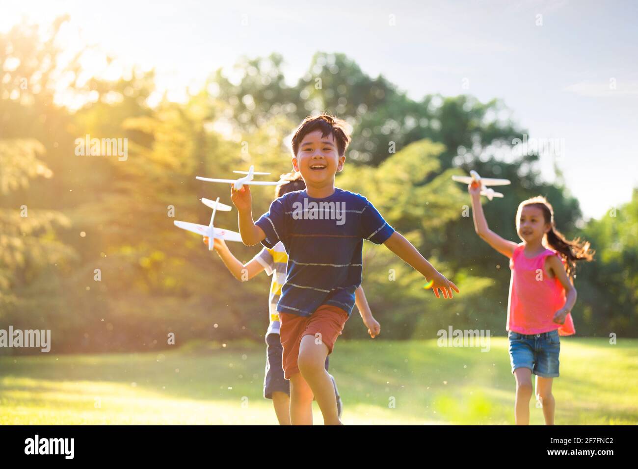 Happy children playing on meadow Stock Photo - Alamy