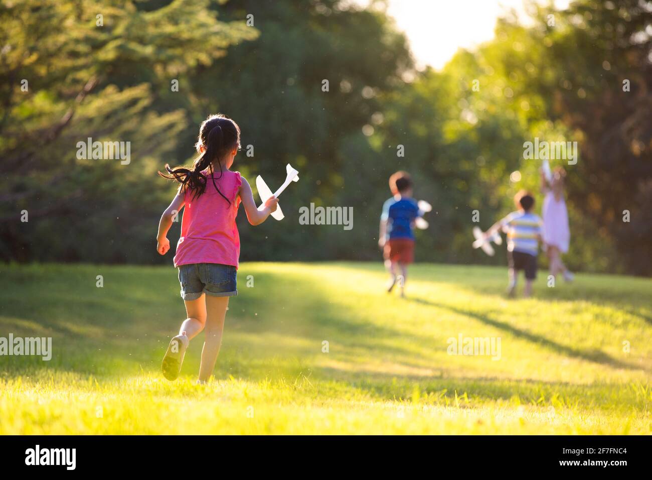 Little children playing on meadow Stock Photo - Alamy