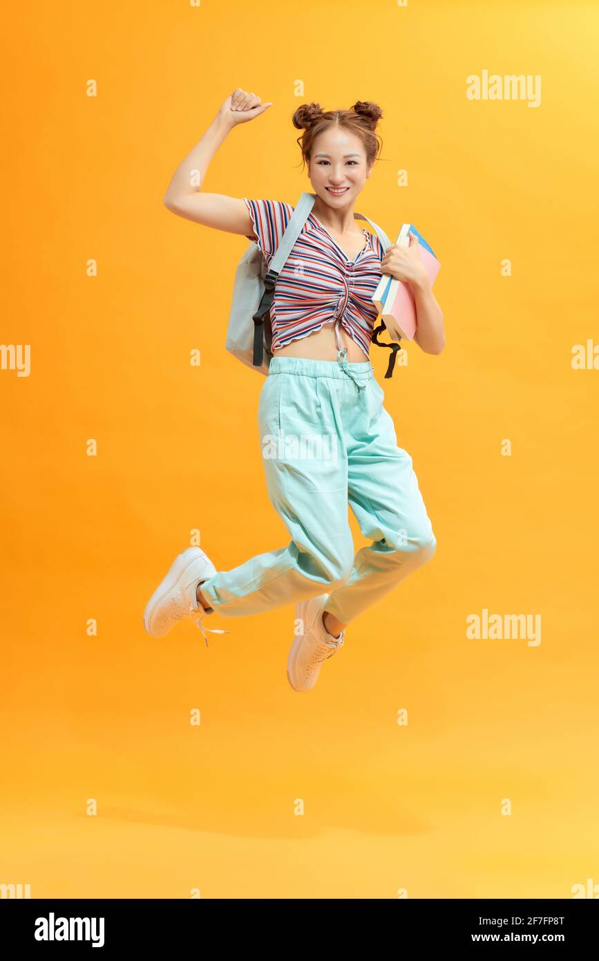 happy student jumping with books Stock Photo - Alamy