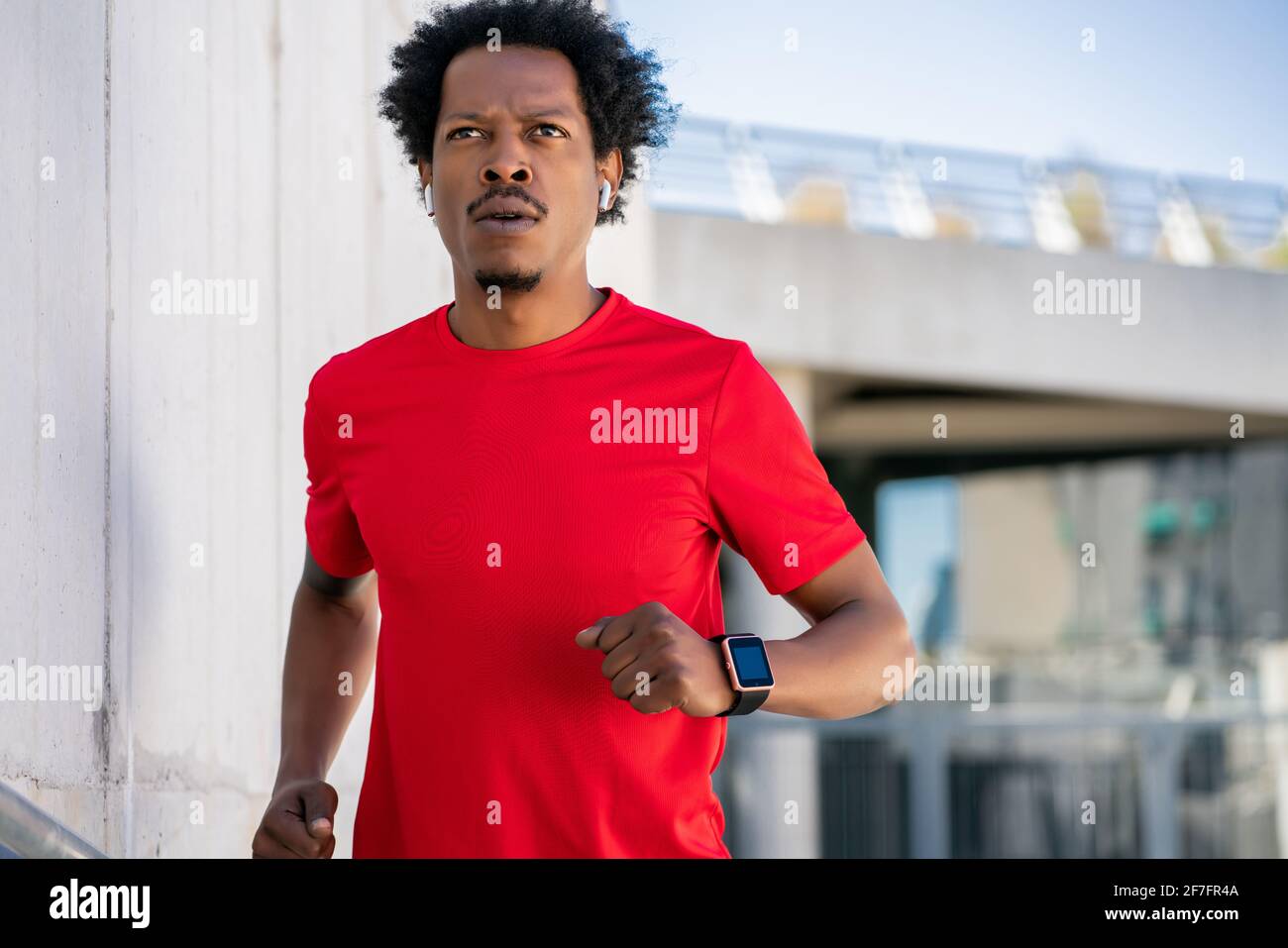 Athletic man running and doing exercise outdoors Stock Photo - Alamy