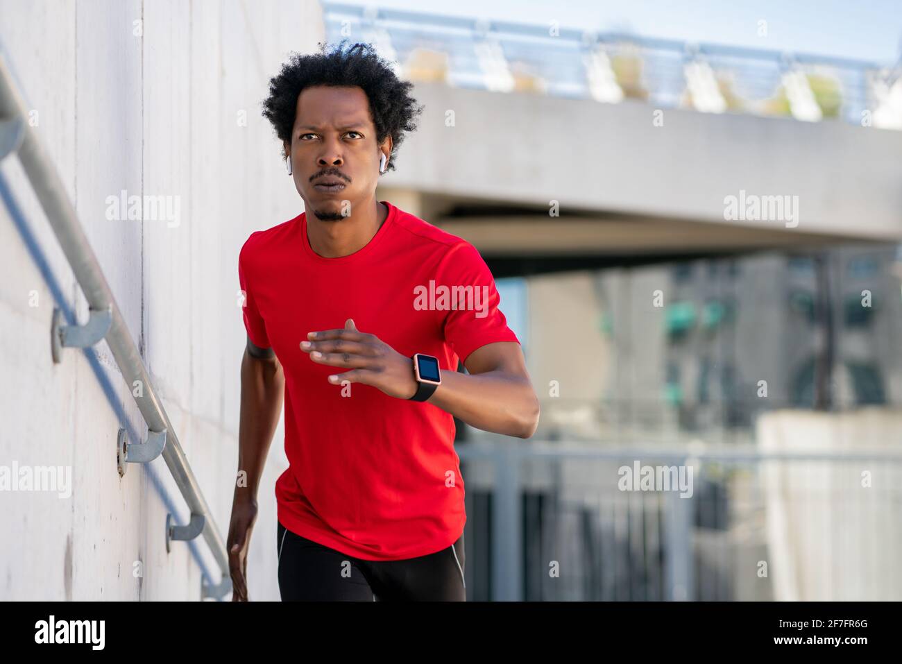 Athletic man running and doing exercise outdoors Stock Photo - Alamy