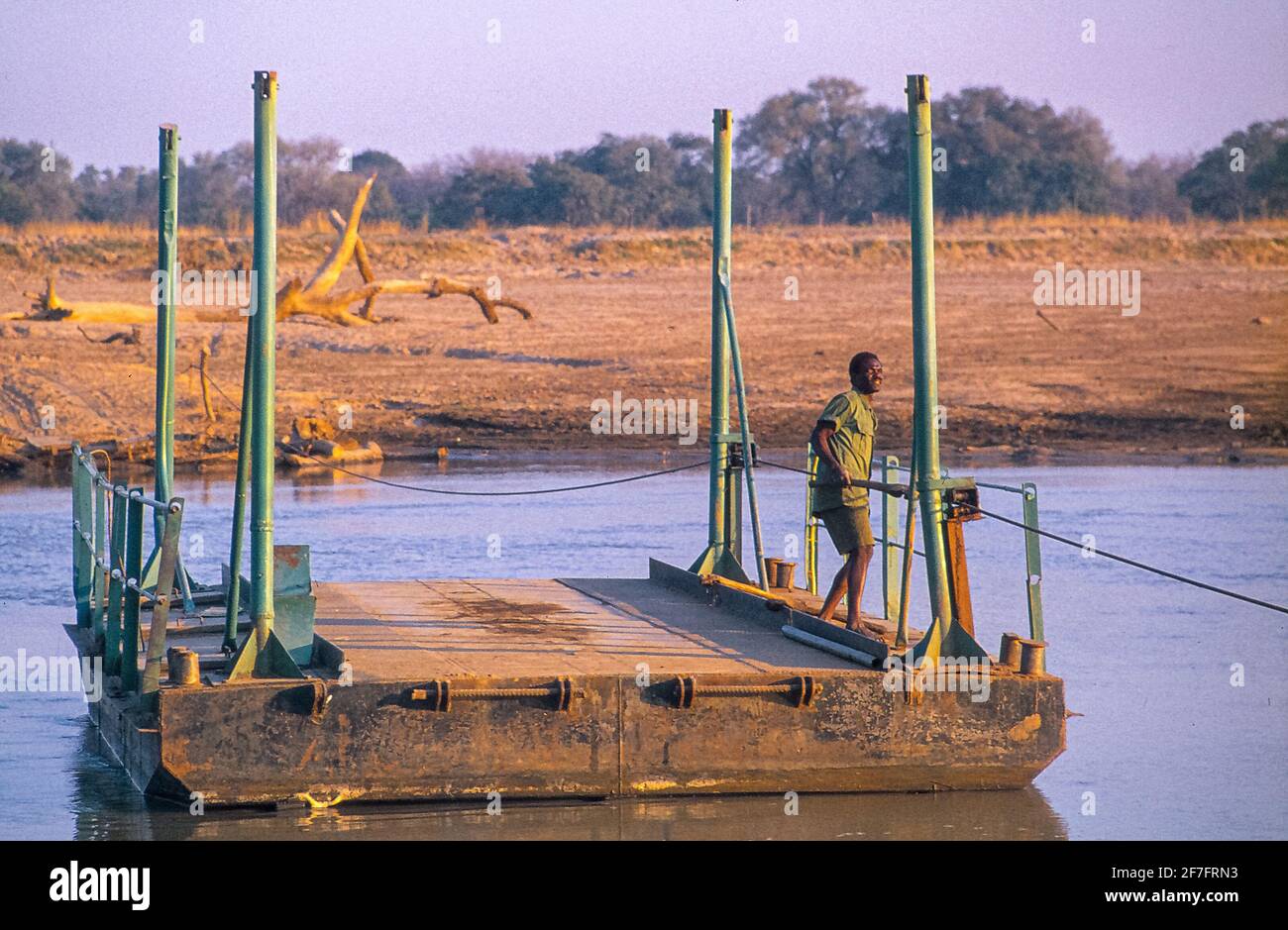 Ferry being winched across the Luangwa River, to enable safari vehicle ...