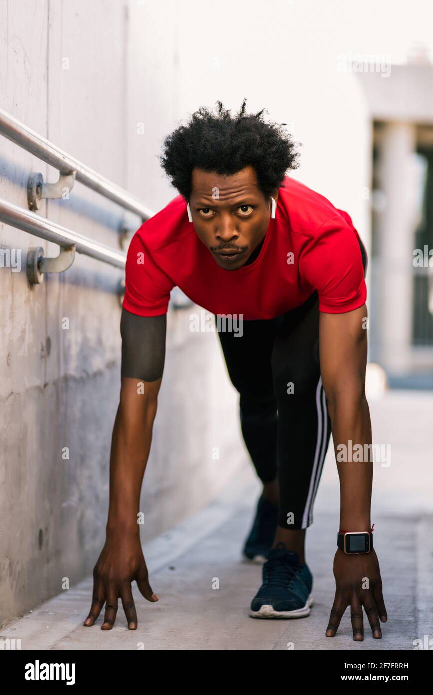 Athlete man in start position preparing to run outdoors Stock Photo - Alamy