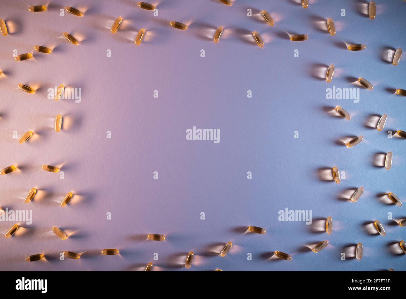 healthy golden fish oil capsules omega 3 vitamins on purple background ...