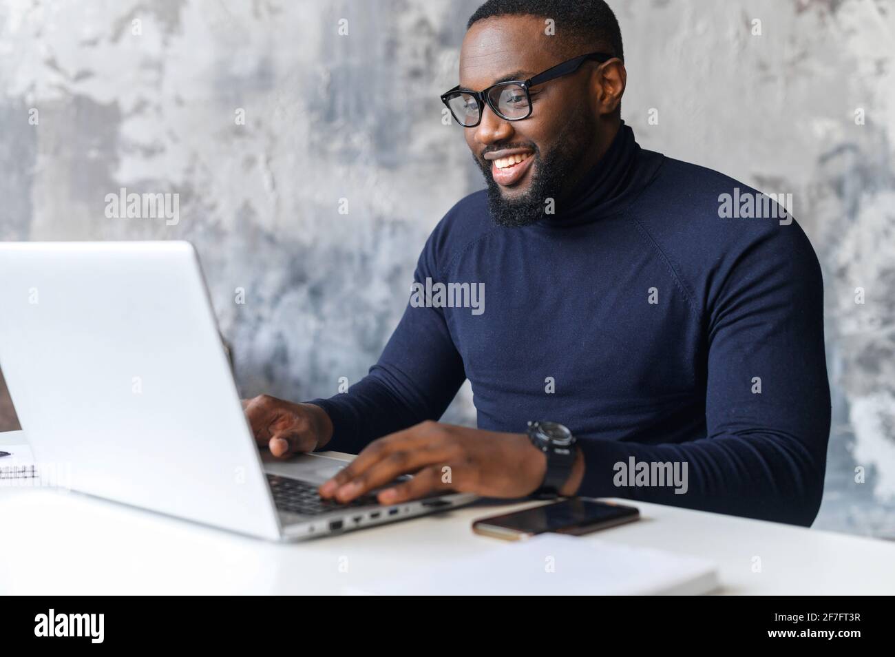 Happy smart African-American businessman wearing stylish eyewear and ...