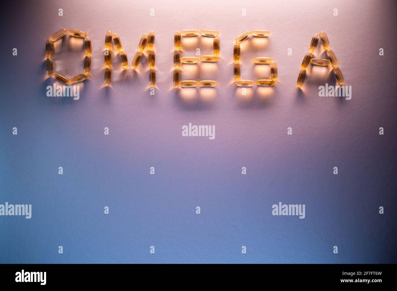 healthy golden fish oil capsules omega 3 vitamins on purple background ...