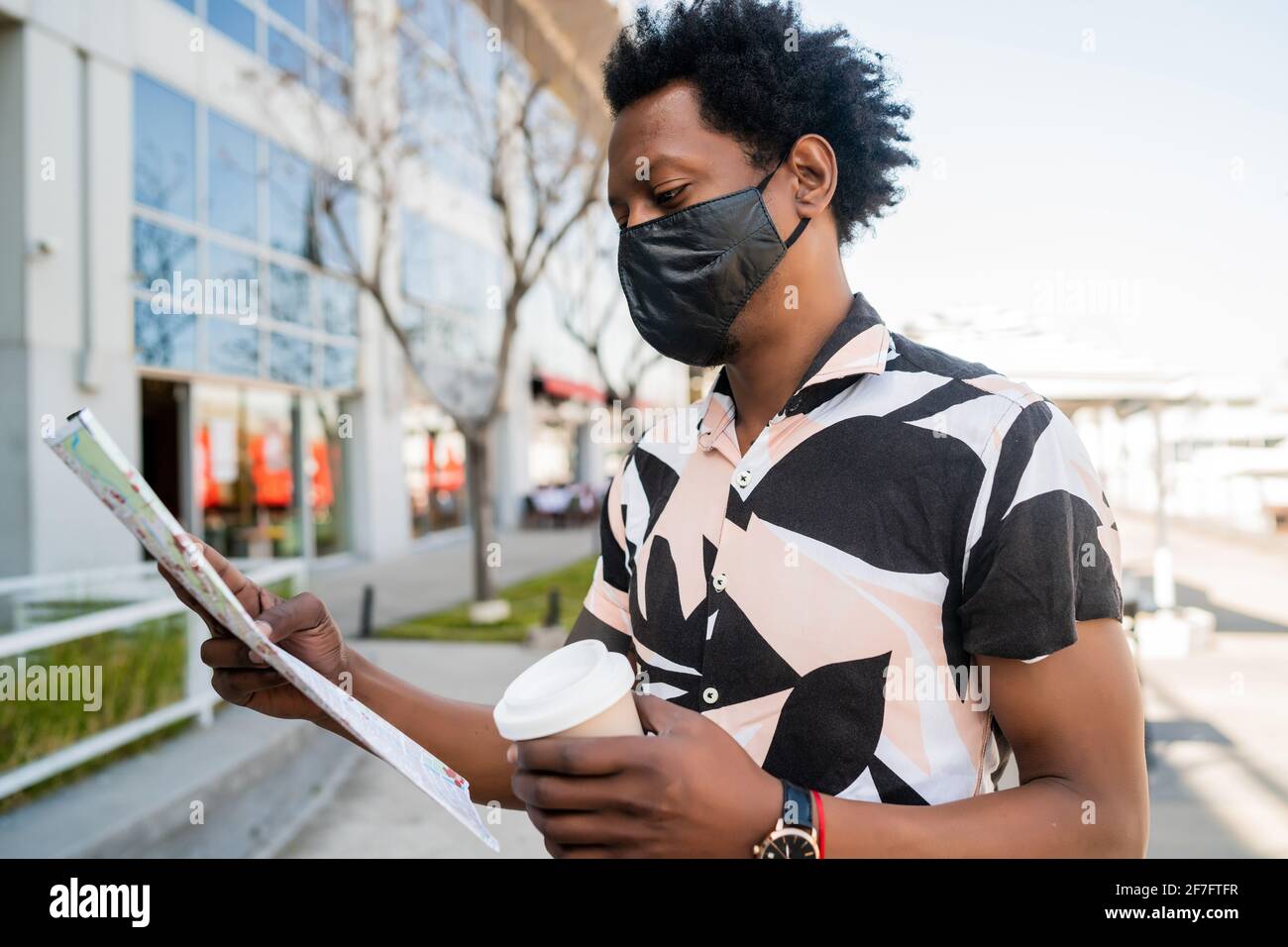 Tourist man looking for directions on map Stock Photo - Alamy