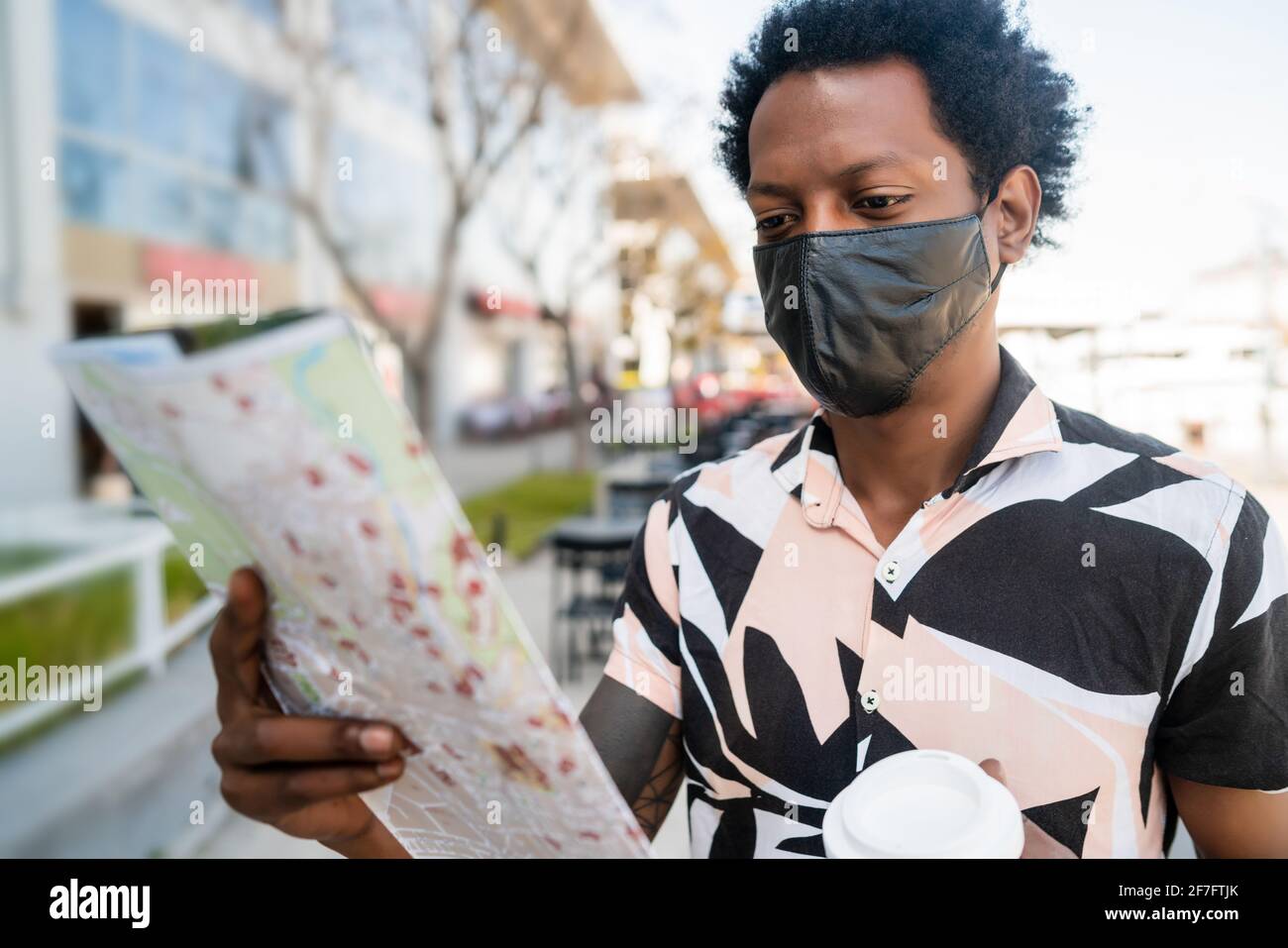 Tourist man looking for directions on map Stock Photo - Alamy