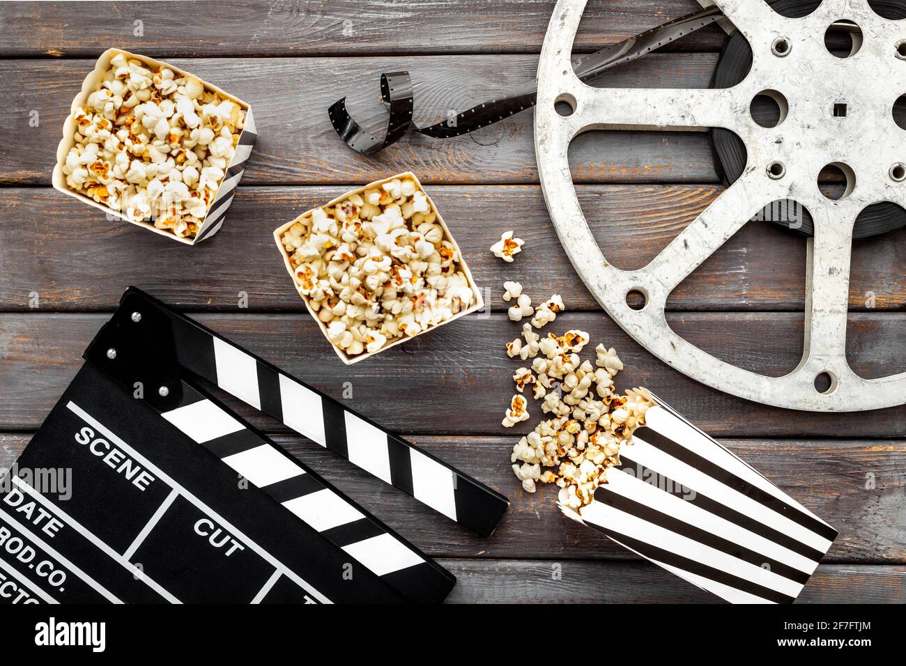 Layout of film reel with popcorn and clapperboard. Cinema concept Stock ...