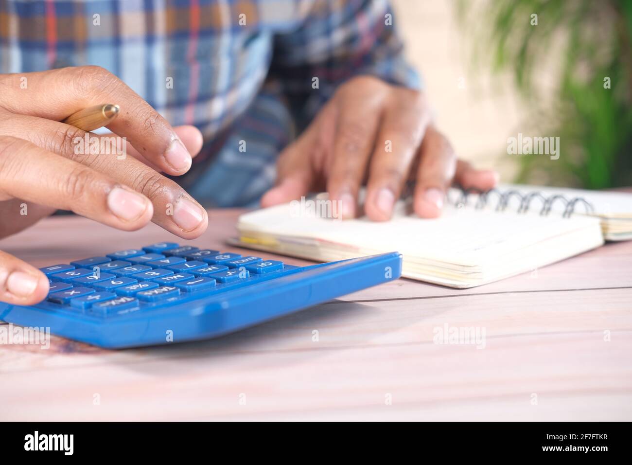 Close up of man hand using calculator Stock Photo - Alamy