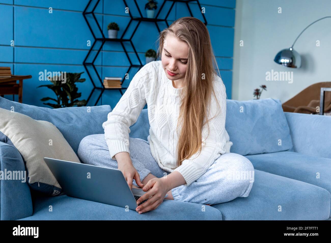Portrait of blonde woman using computer - work at home Stock Photo - Alamy