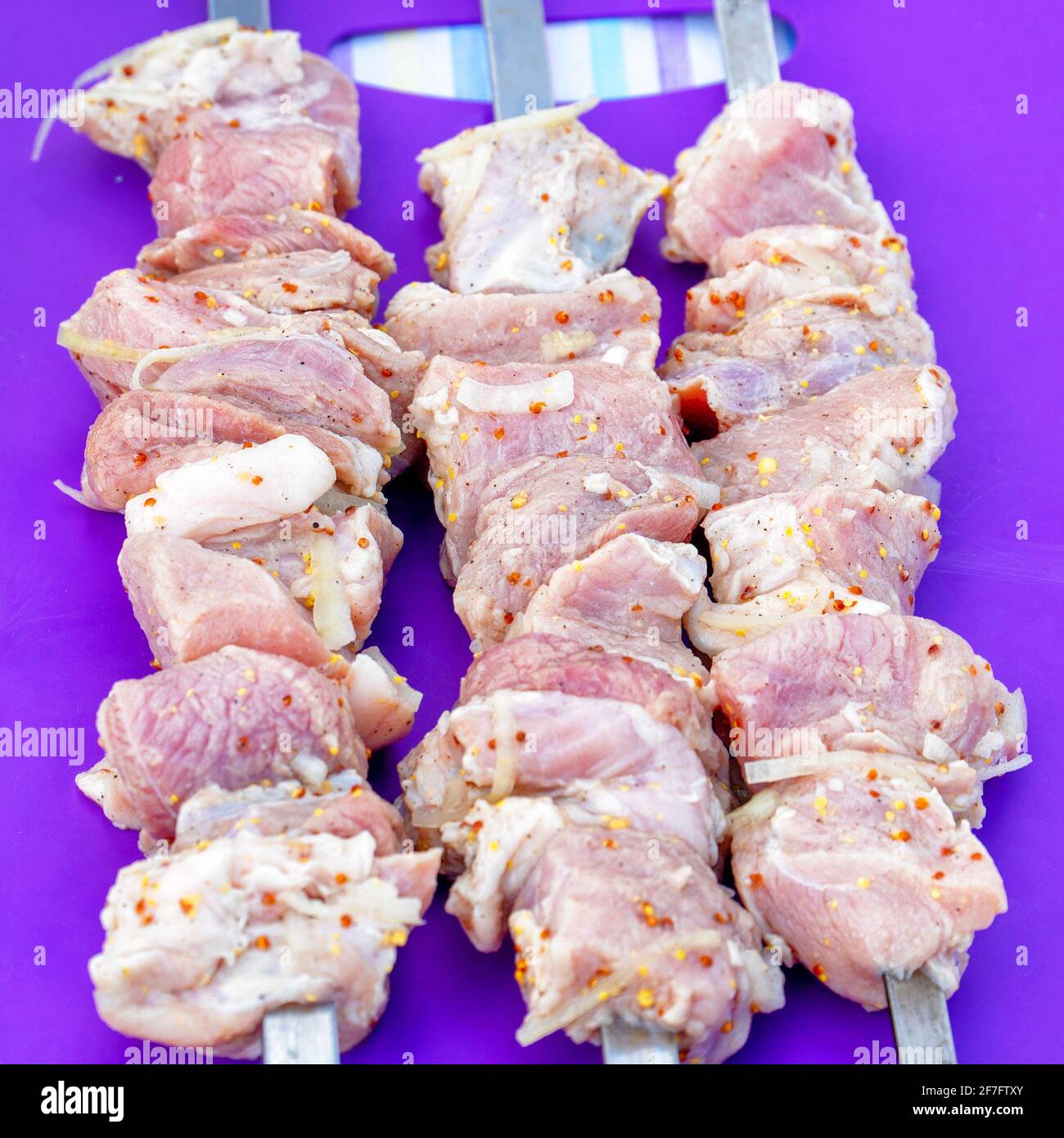 Raw meat for barbecue on skewers on cutting Board Stock Photo - Alamy
