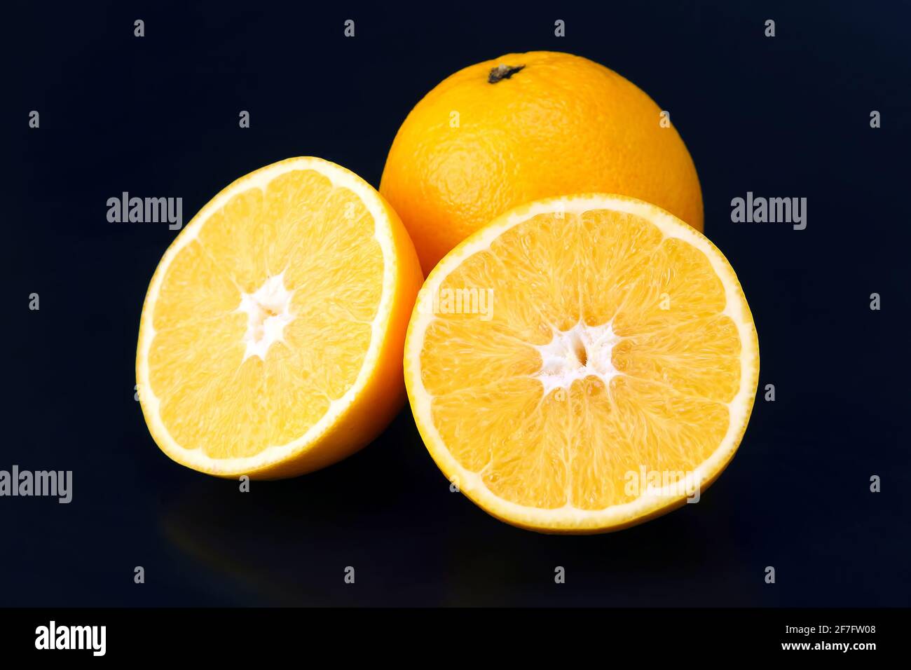 Citrus fruit. Cut and whole orange on dark background Stock Photo - Alamy
