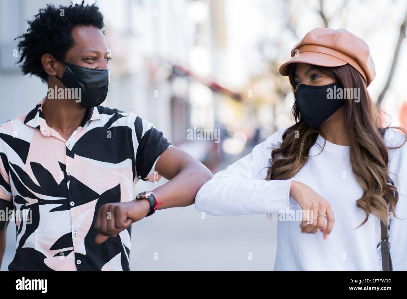 Couple tap each other with elbows to say hello Stock Photo - Alamy