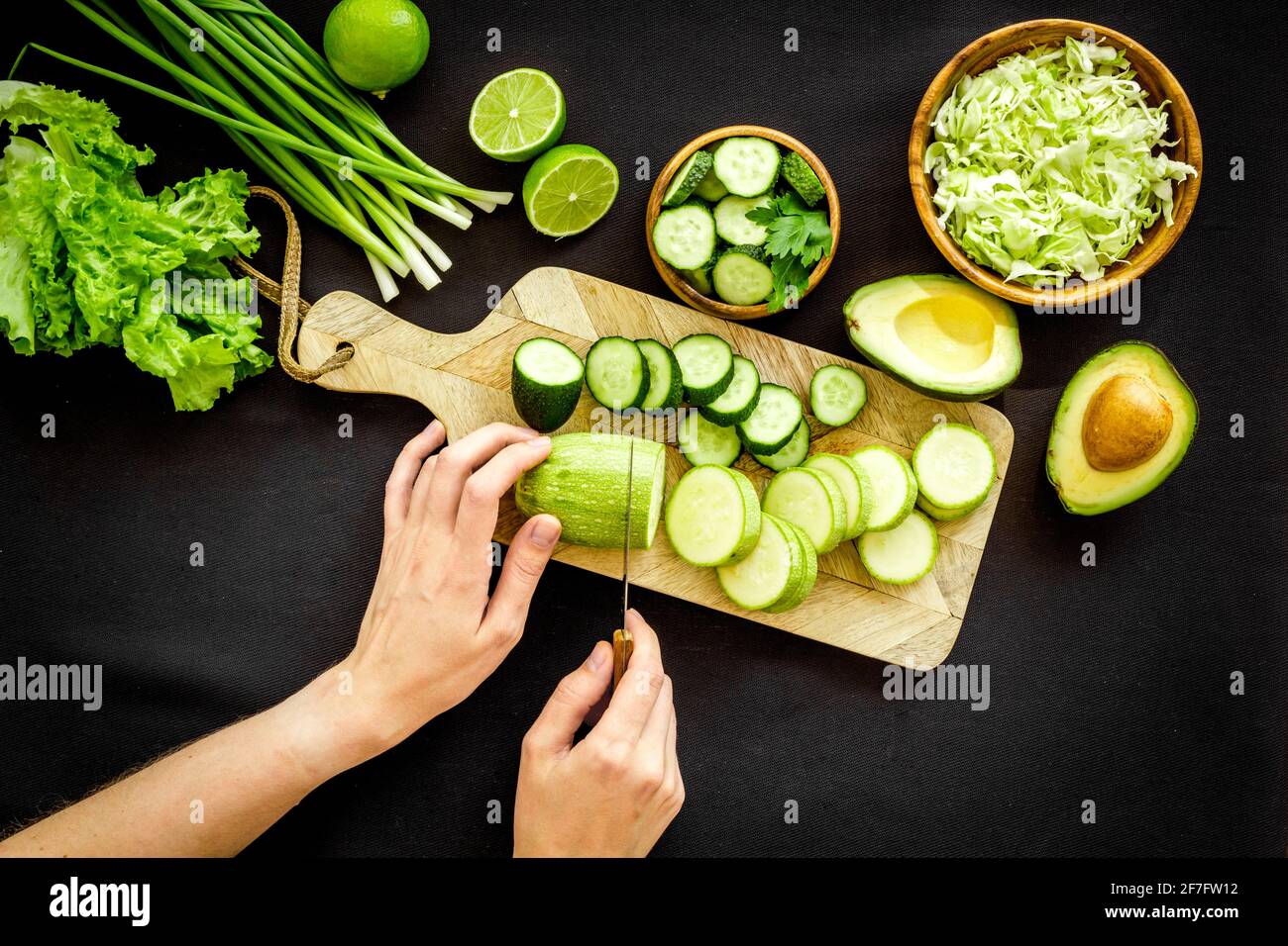 Cooking fresh salad with green vegetables. Raw food diet Stock Photo ...