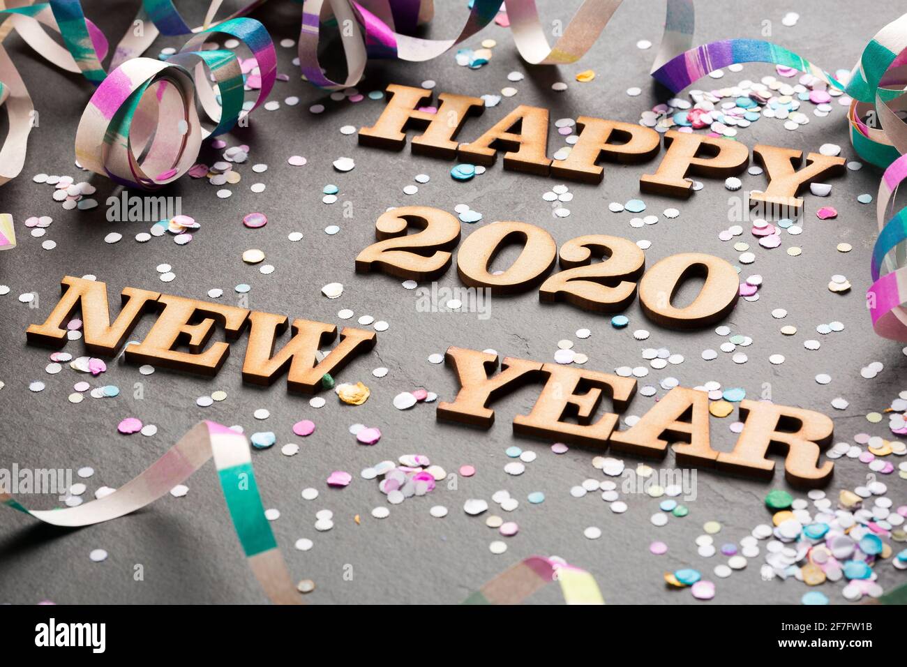 Happy year 2020 - Letters in wood. Black background Stock Photo - Alamy