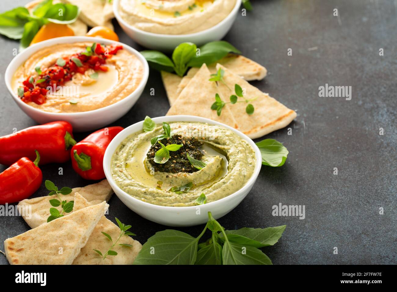 Hummus board with pita and different kinds of hummus Stock Photo - Alamy