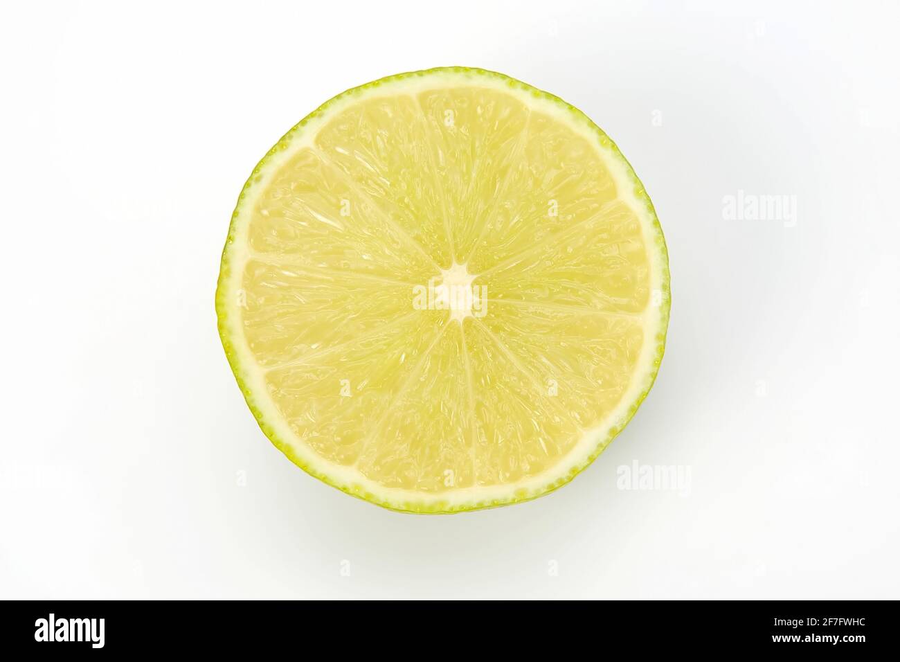 Cut citrus fruit of green lemon on white background Stock Photo - Alamy