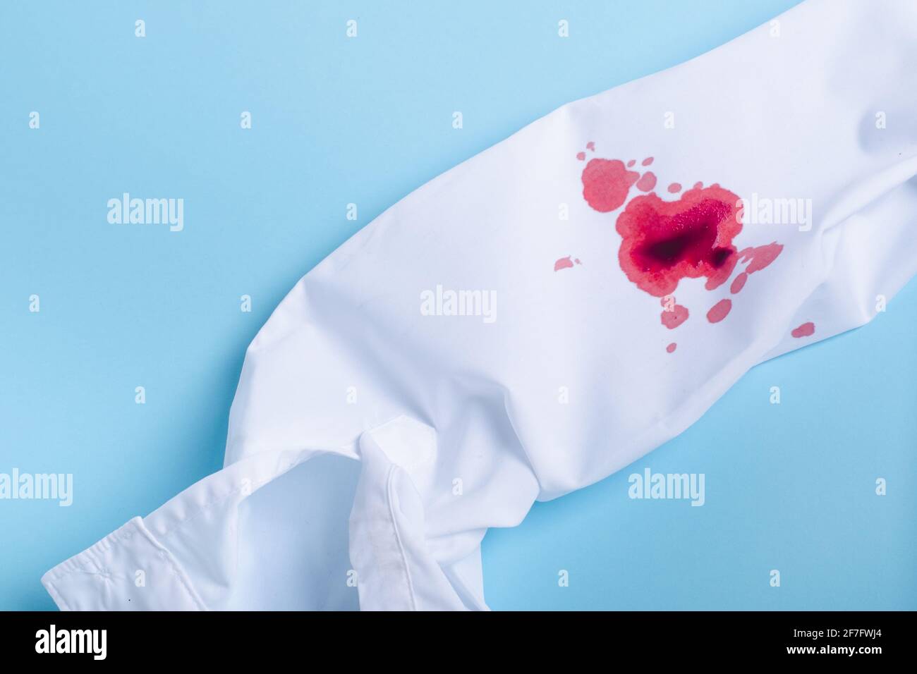 White clothes with a blood stain. concept stain removal. concept stain ...