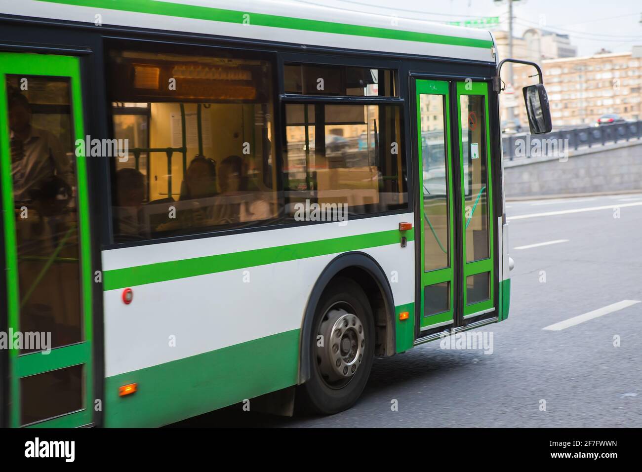 white city bus goes along street Stock Photo - Alamy
