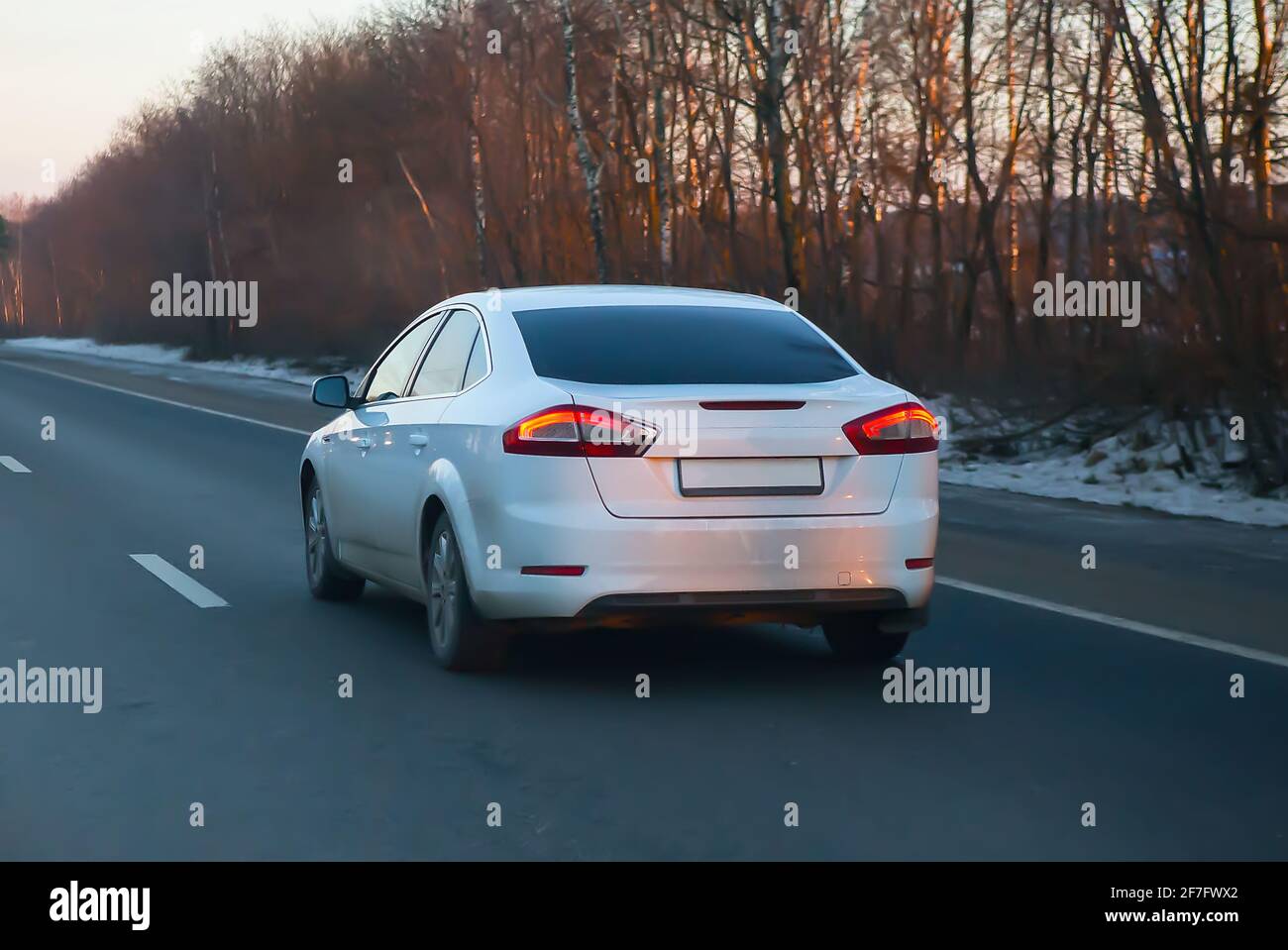 white car moves in winter on a country highway Stock Photo - Alamy