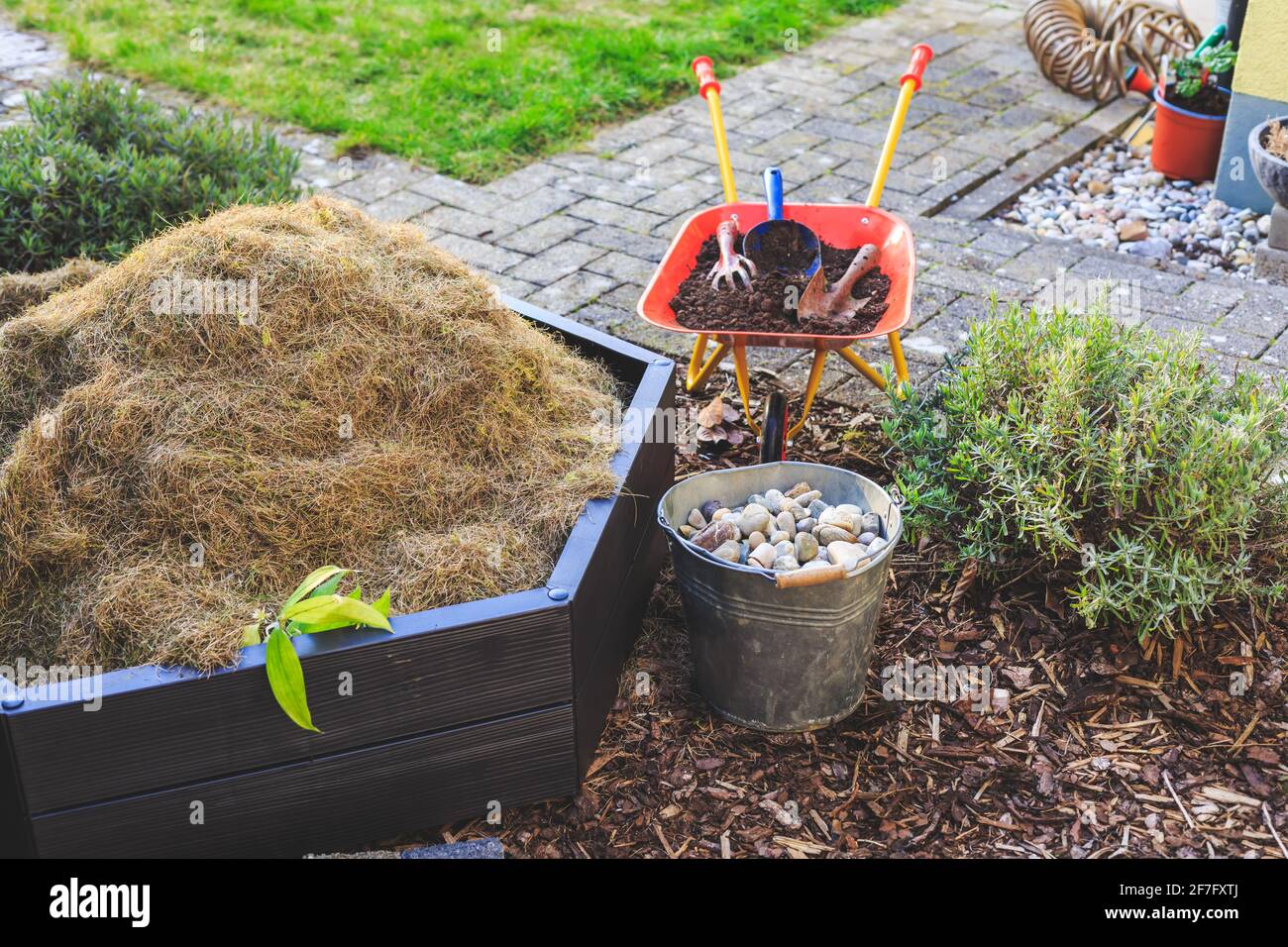 Gardening - composter, bucket with stones and wheelbarrow with soil ...
