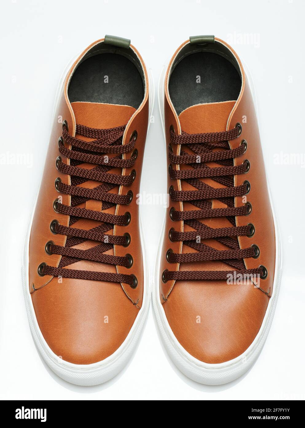 Perspective view of pair brown sneakers isolated on white studio ...