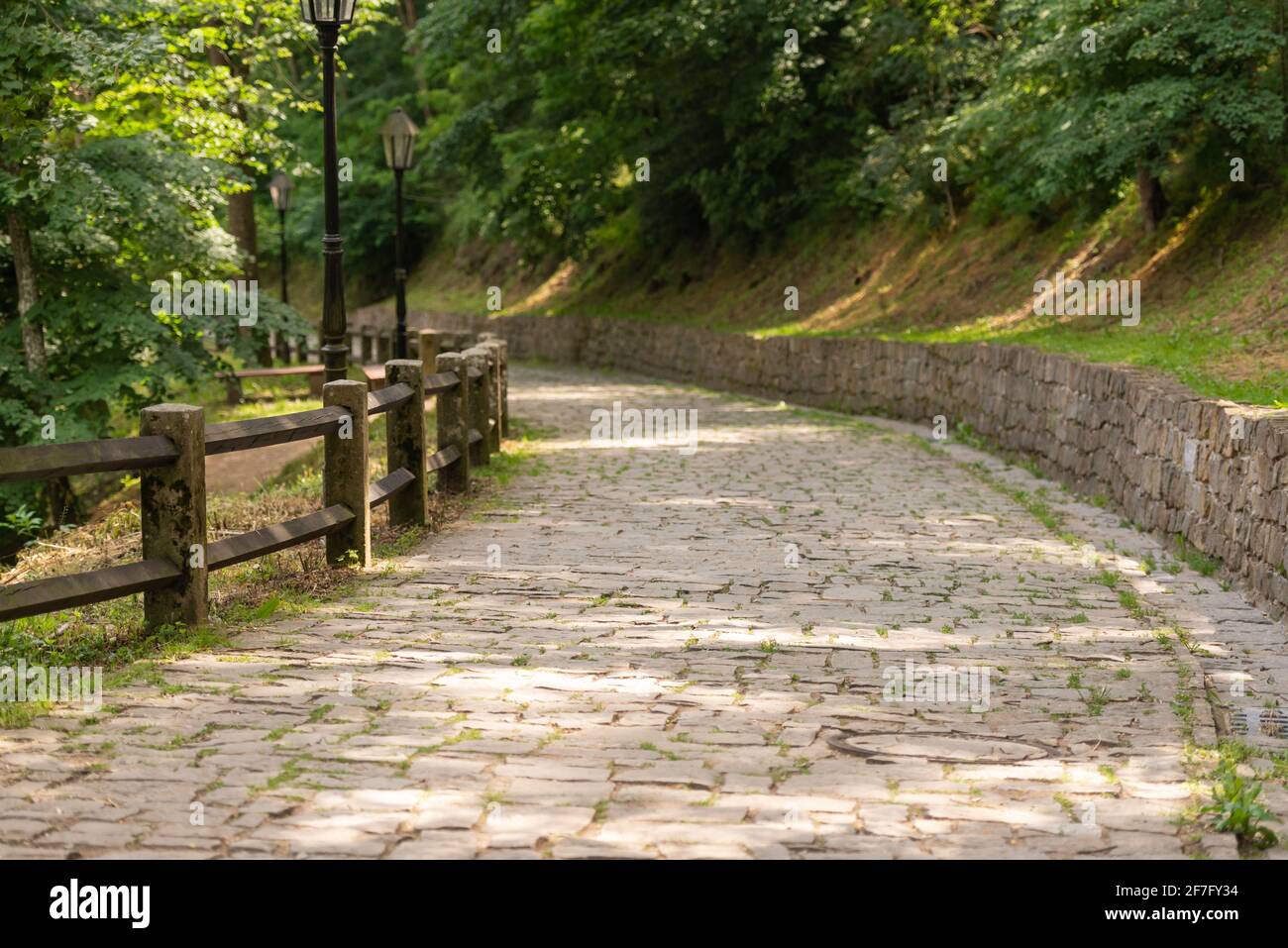 A stone paved path leading down from the mountain. Stone path and wall ...