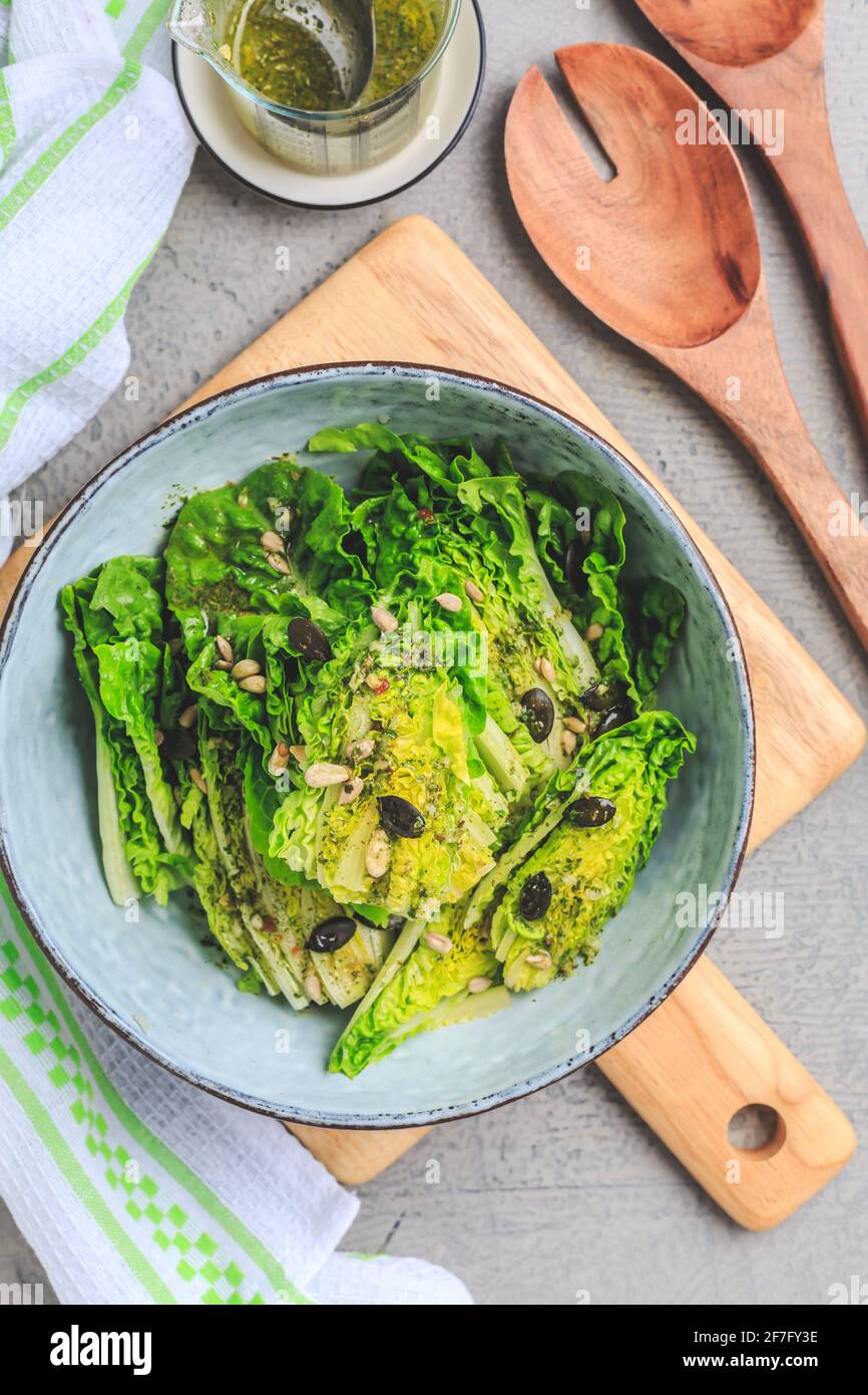Lettuce salad with olive oil dressing in bowl Stock Photo - Alamy
