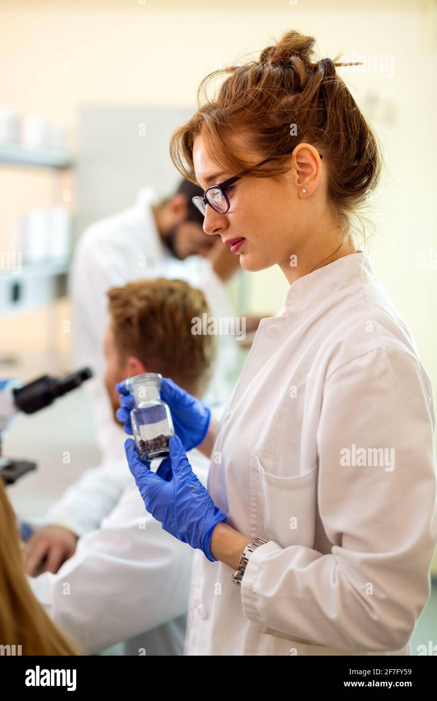 Attractive young woman scientist working in laboratory Stock Photo - Alamy