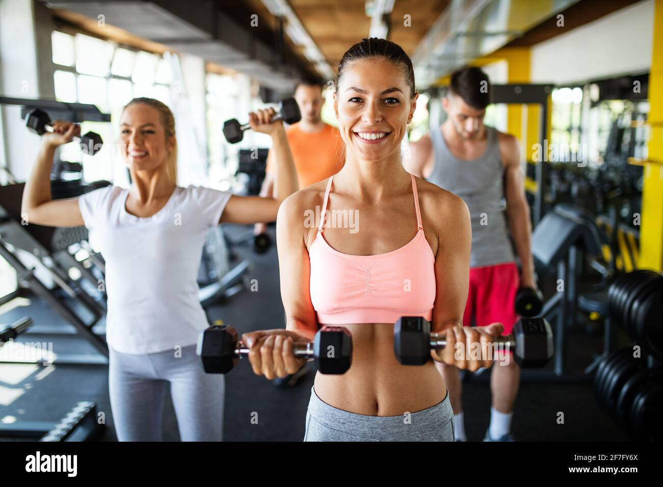 Group of fit young people exercising at the gym Stock Photo - Alamy