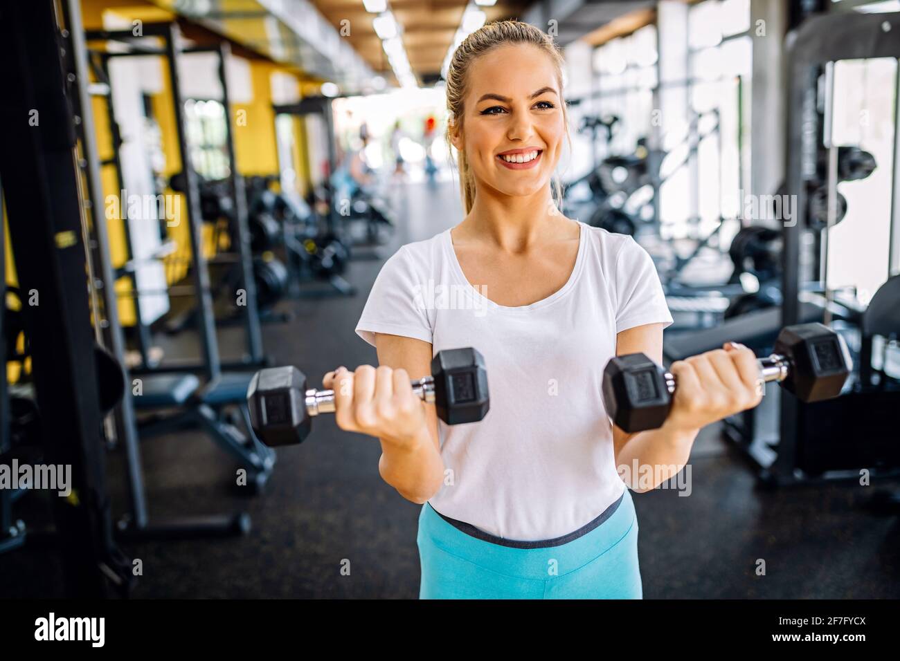 Happy fit fitness woman working out in gym Stock Photo - Alamy