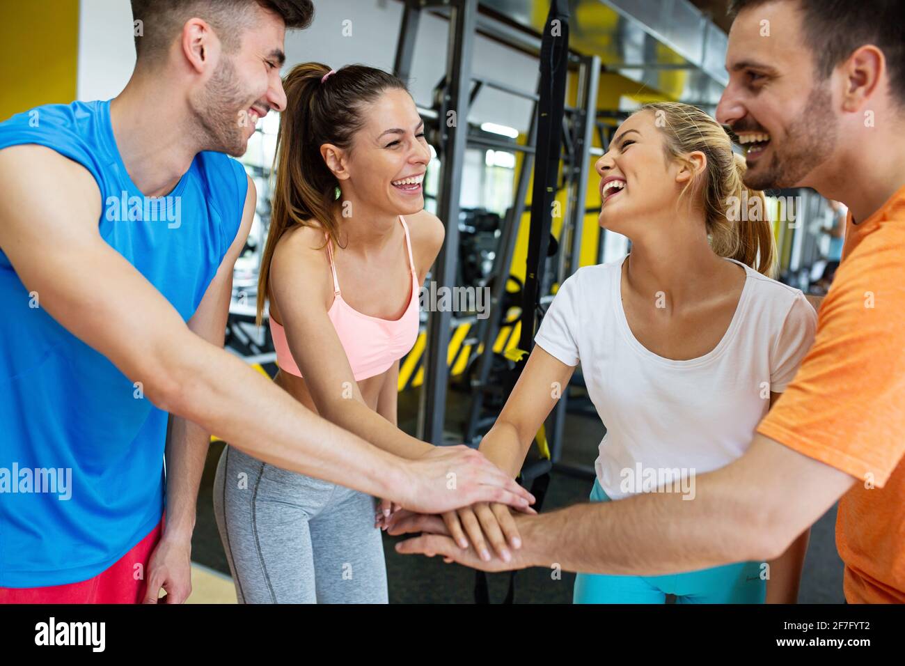 Group of young fit people doing exercises in gym to stay healthy Stock ...
