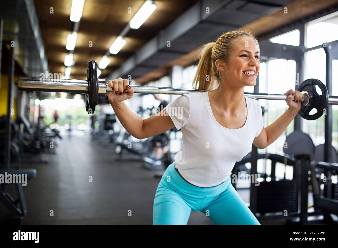 Happy fit fitness woman working out in gym Stock Photo - Alamy