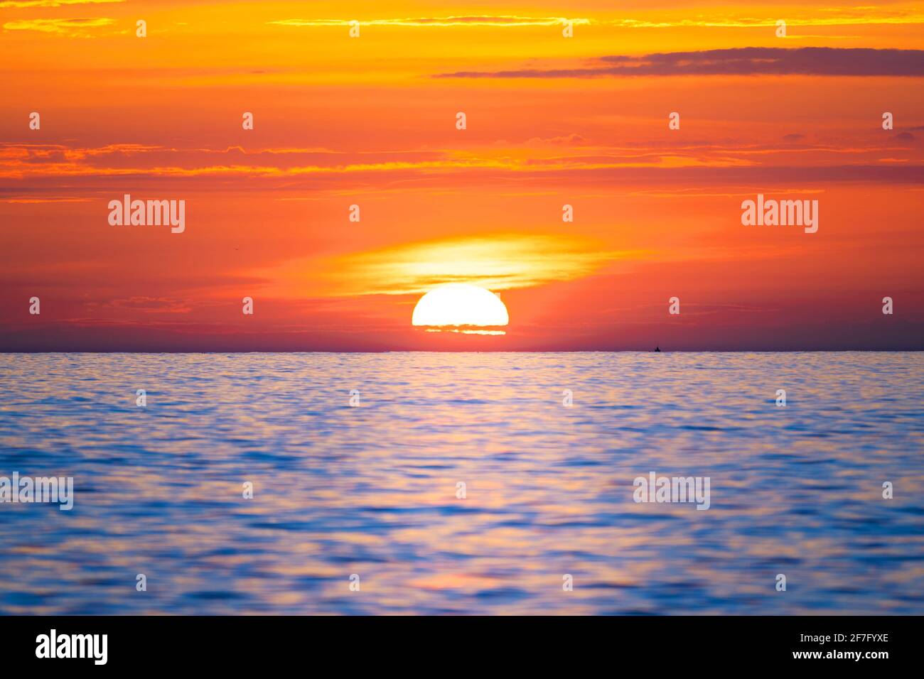 Sun rising in the sea. Beautiful sunrise on the ocean with a big and ...