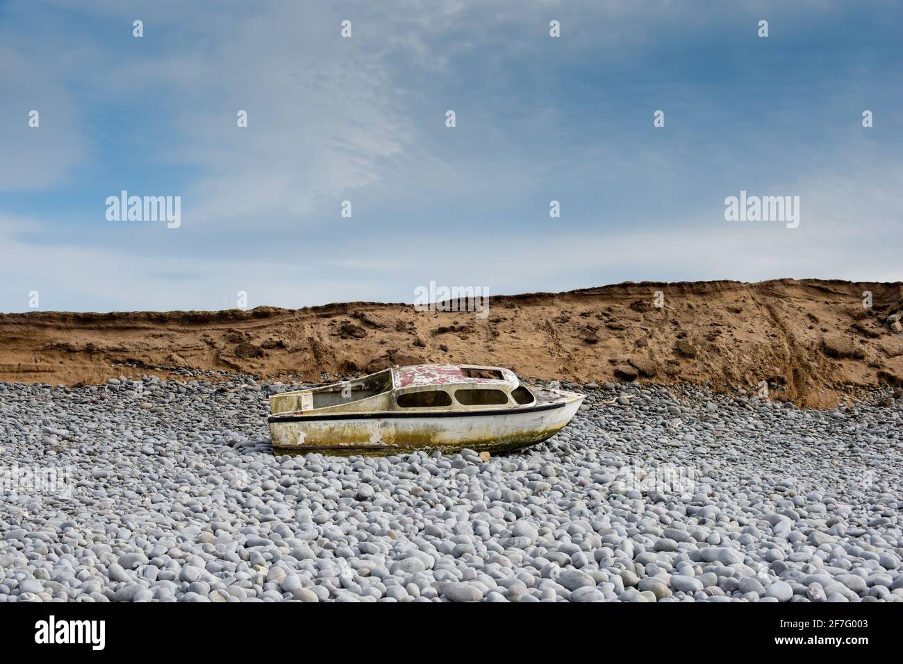 Ship wreck of an old boat washed up on a rocky beach Stock Photo - Alamy