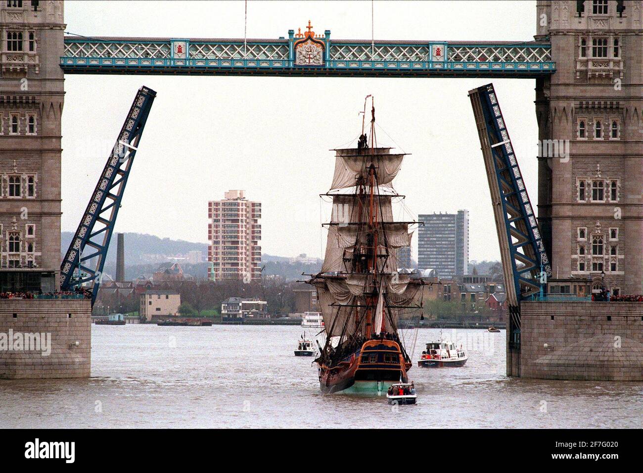 A replica of the ship Endeavour on the River Thames passing under Tower ...
