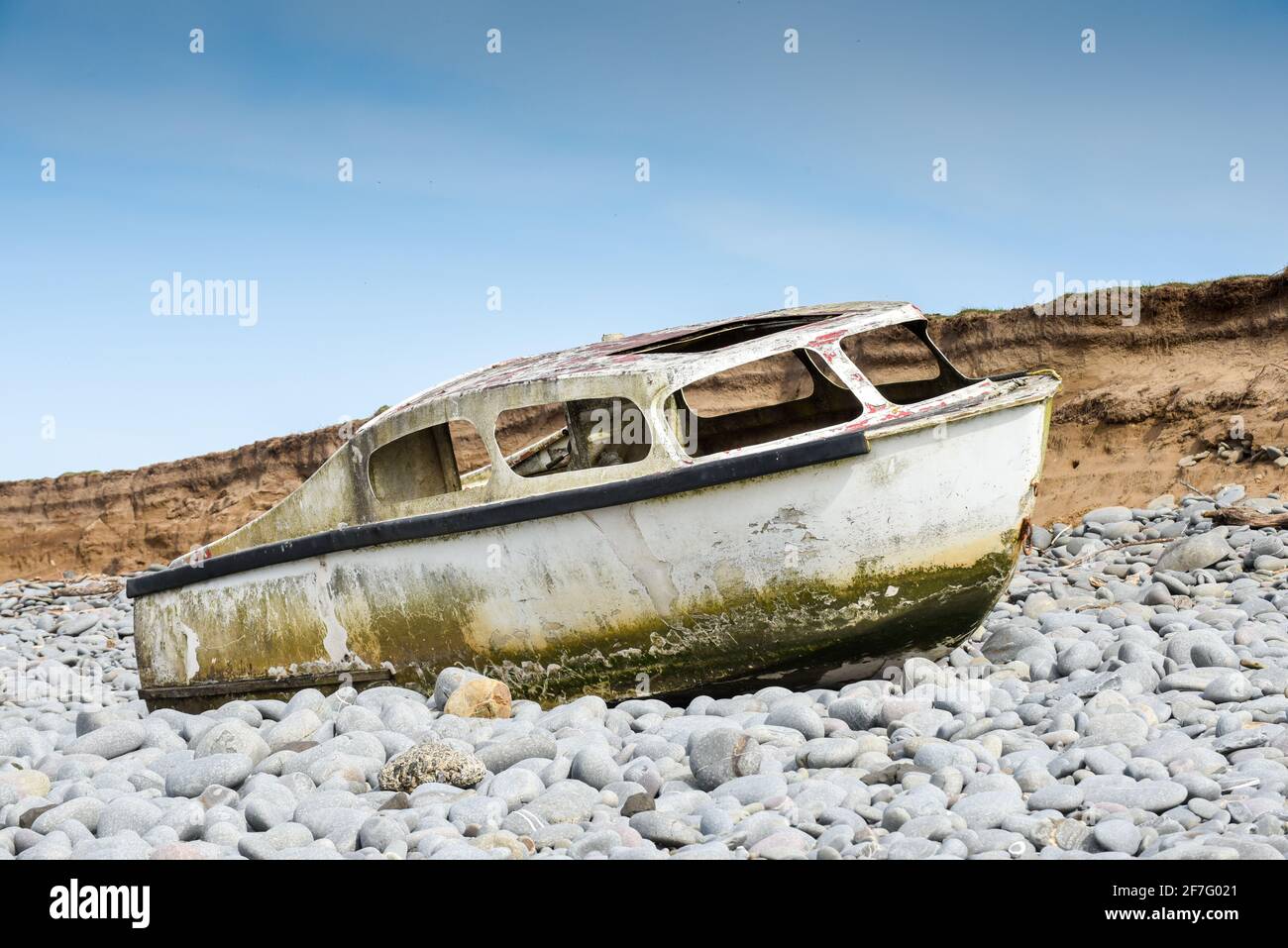 Ship wreck of an old boat washed up on a rocky beach Stock Photo - Alamy