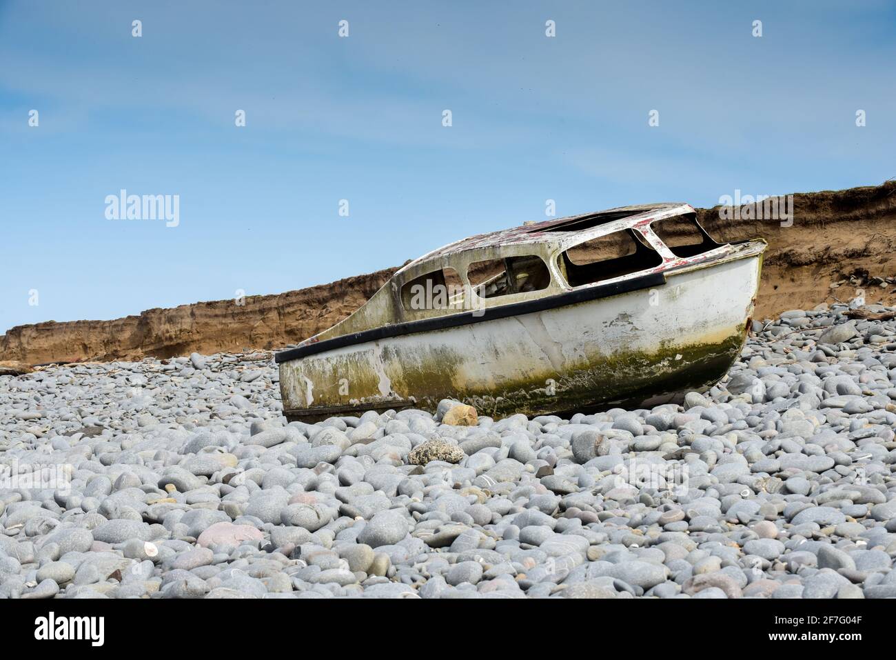 Ship wreck of an old boat washed up on a rocky beach Stock Photo - Alamy