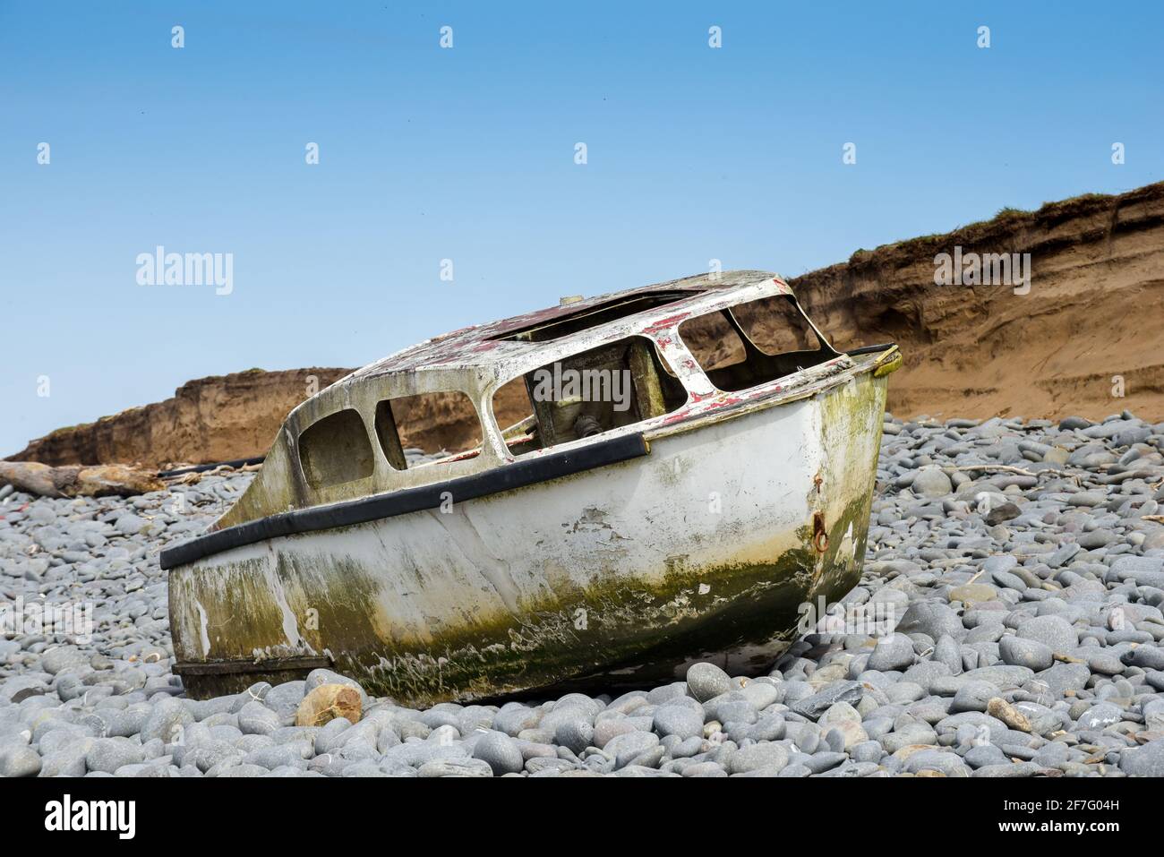 Ship wreck of an old boat washed up on a rocky beach Stock Photo - Alamy
