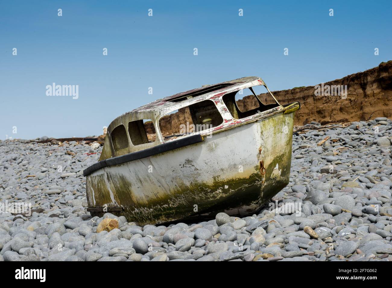 Ship wreck of an old boat washed up on a rocky beach Stock Photo - Alamy